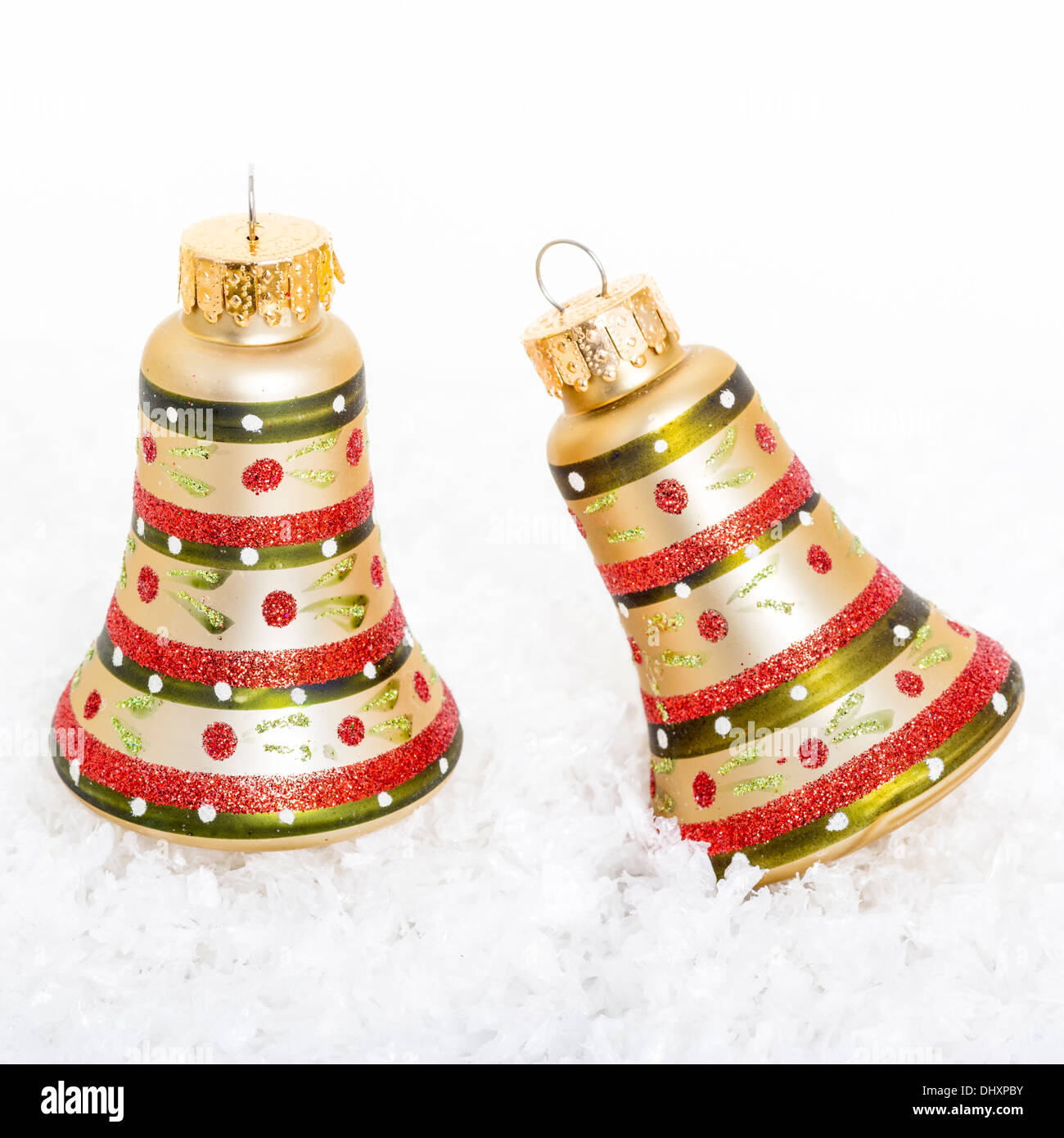 Glass Christmas bell ornaments on snow Stock Photo - Alamy