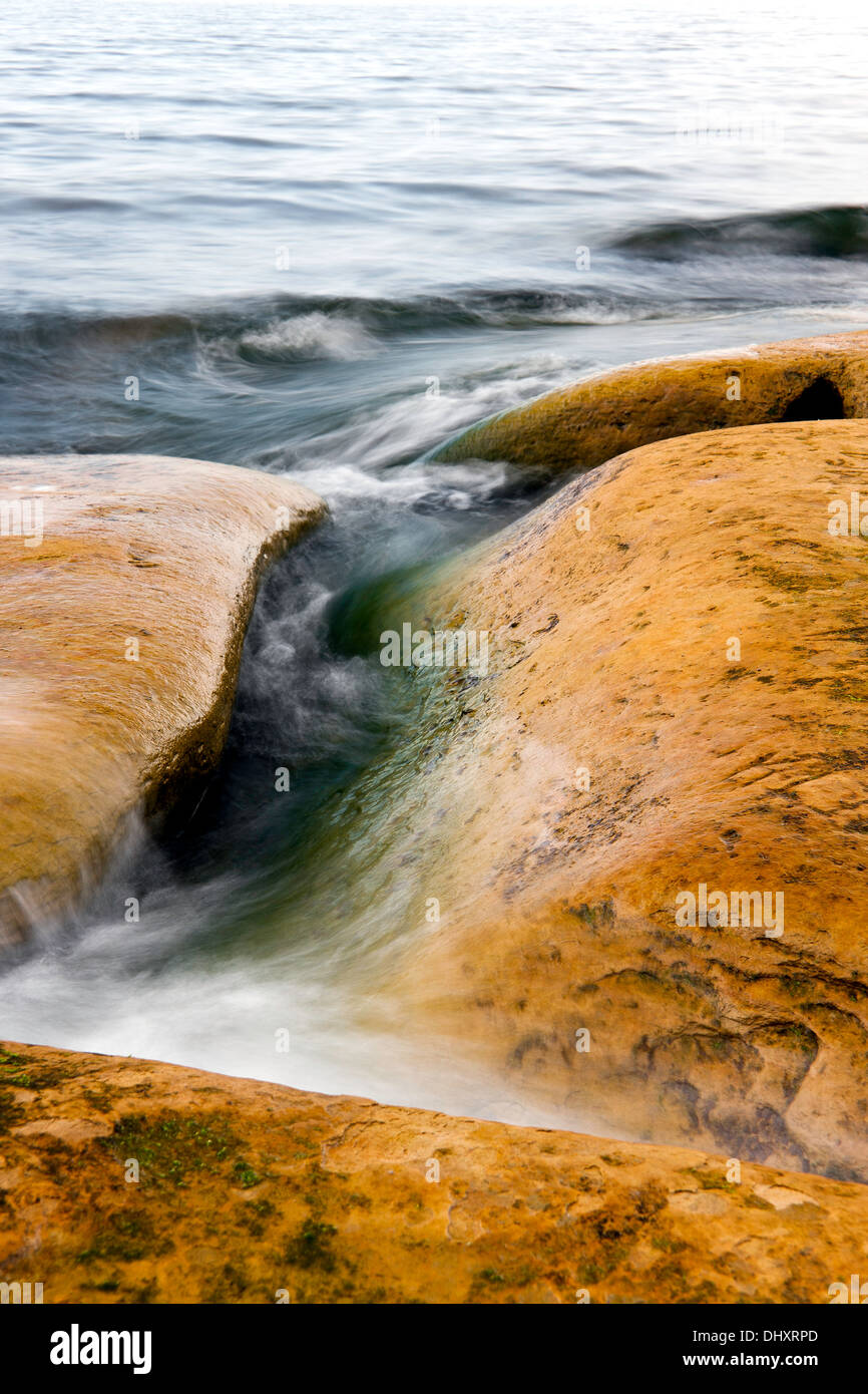 Round yellow rocks in sea Stock Photo - Alamy