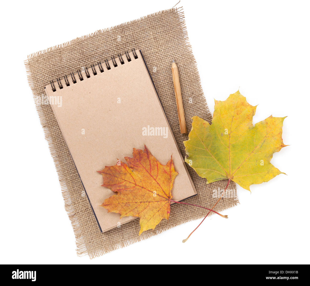 Brown paper notepad with pencil and autumn leaf over burlap. Isolated ...