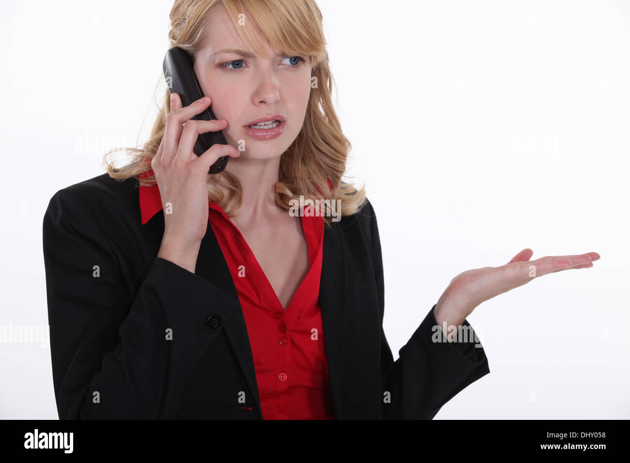 Blond having telephone dispute Stock Photo - Alamy