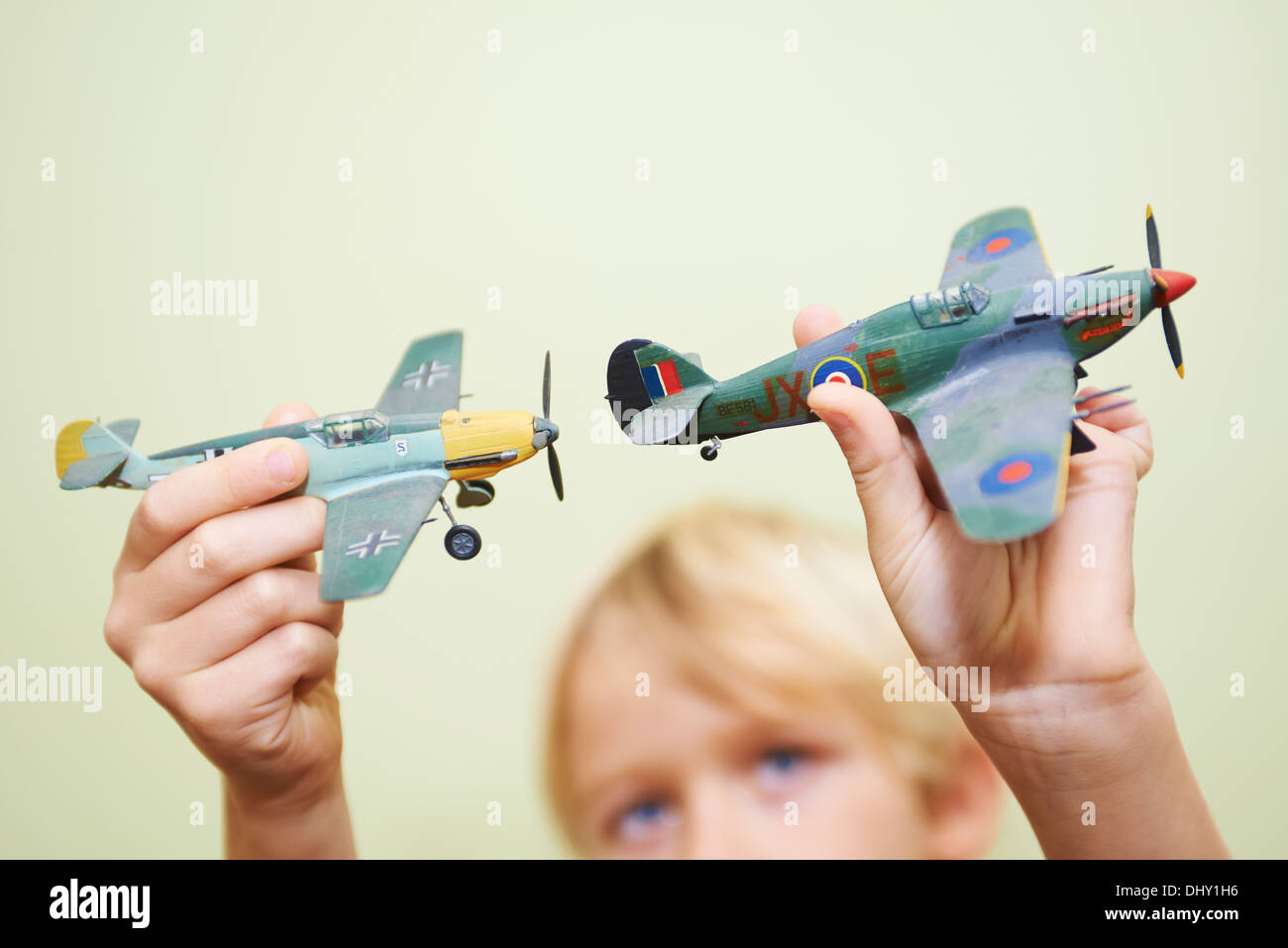 Child blond boy playing - flying with world war II airplanes fighters ...