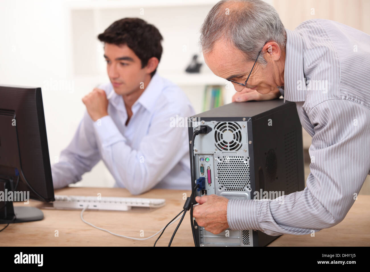 Grandfather installing computer Stock Photo - Alamy