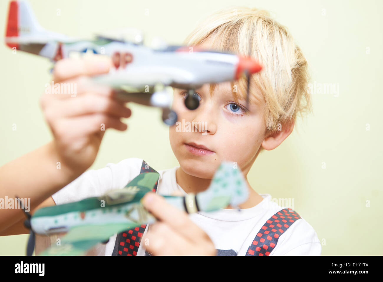 Child blond boy playing - flying with world war II airplanes fighters ...