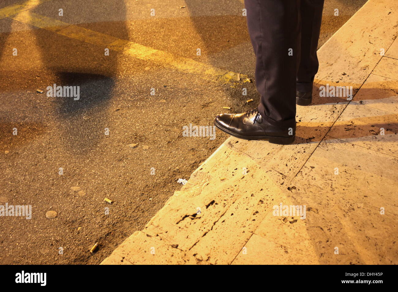 businessman standing on pavement in street road city town at night ...