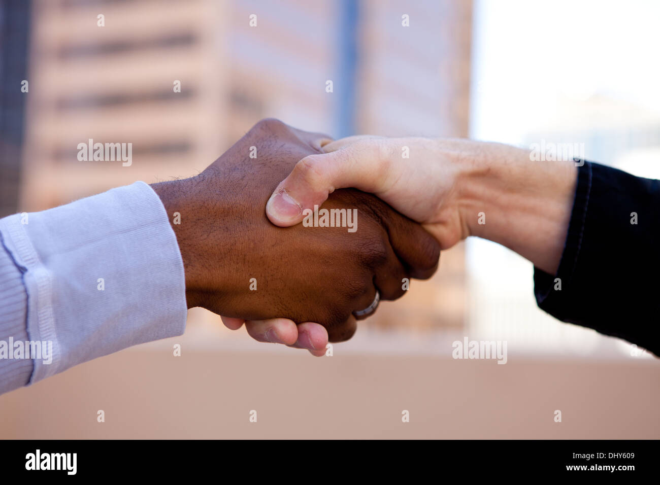 Handshake of Friendship between two races Stock Photo - Alamy