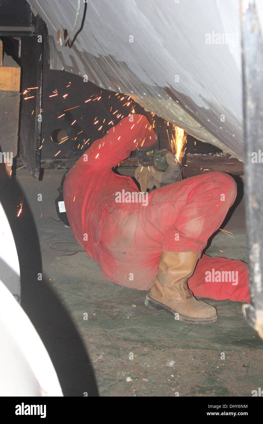 A welder welding a repair on a steam boiler Stock Photo - Alamy