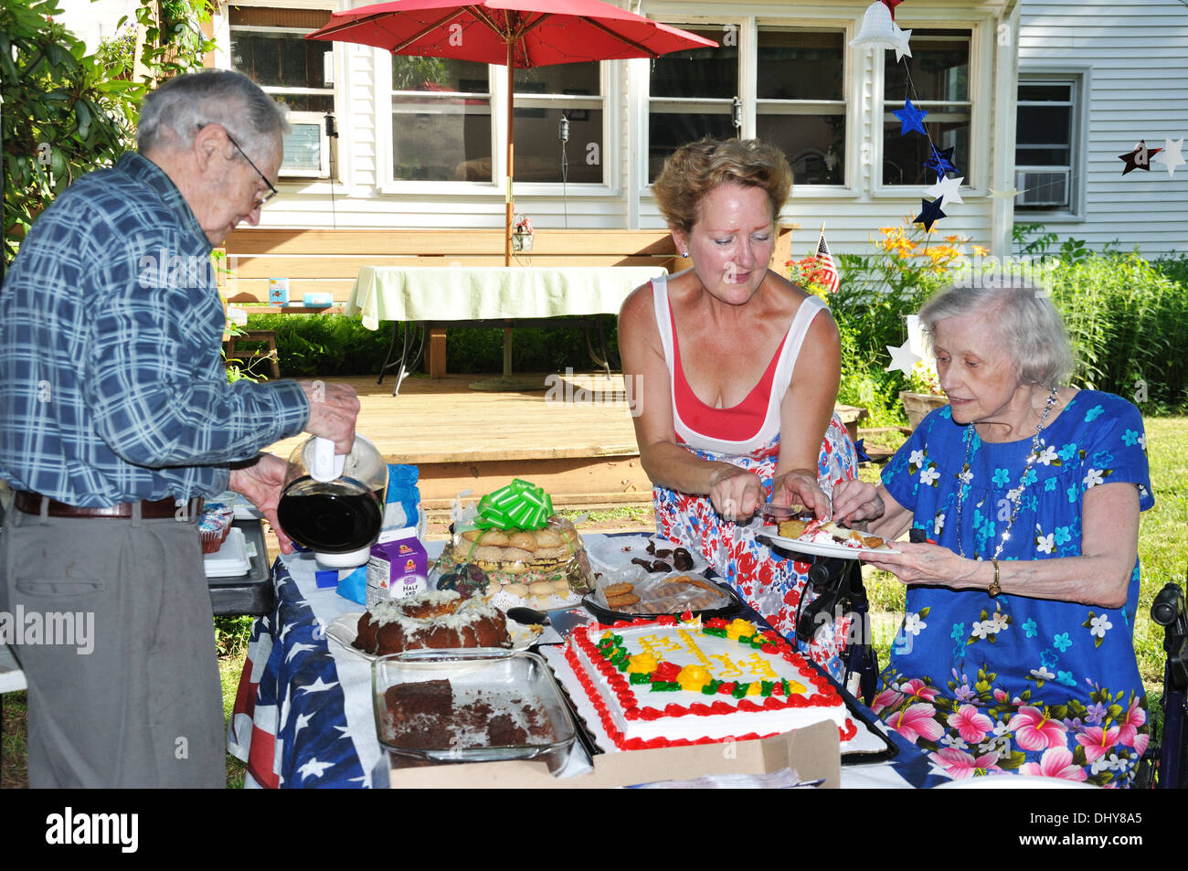 Family celebrating grandma's birthday Stock Photo - Alamy