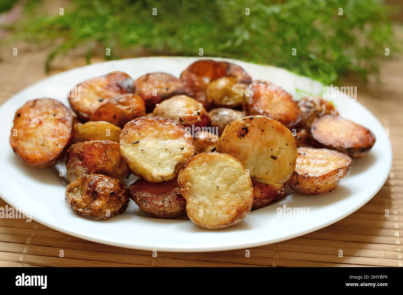 Roasted potato on white plate Stock Photo - Alamy