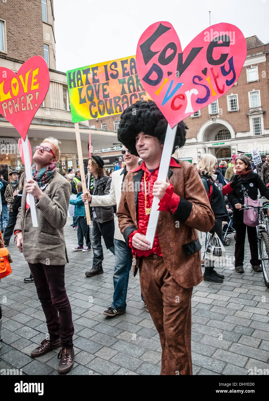 Men in 70's disco outfits hold 'Love" placards during the Exeter ...