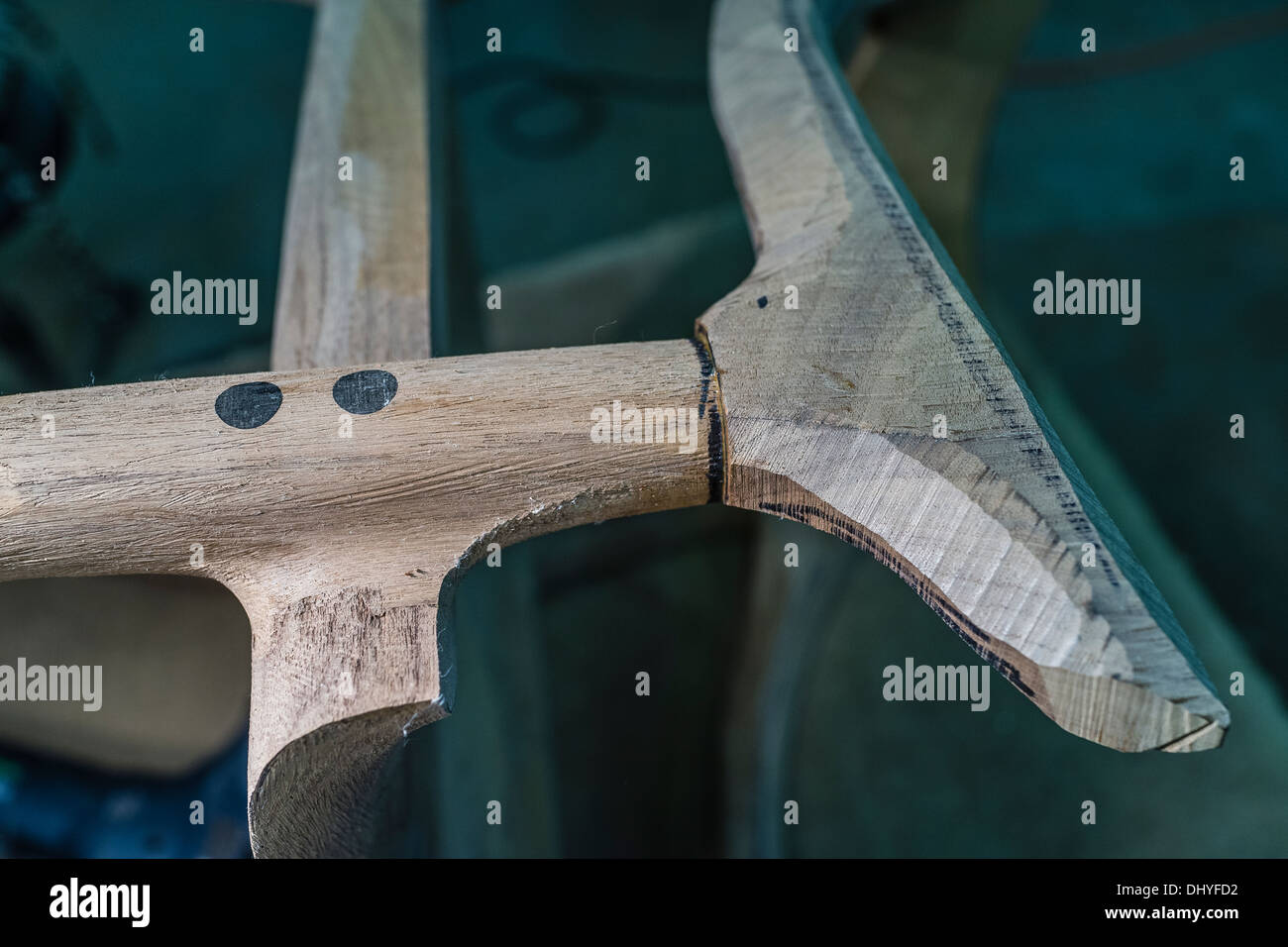 Close-up of a wood joint on a chair during construction at the shop of ...