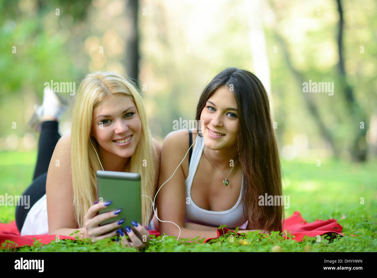 Happy teenage girls enjoying nature with tablet Stock Photo - Alamy