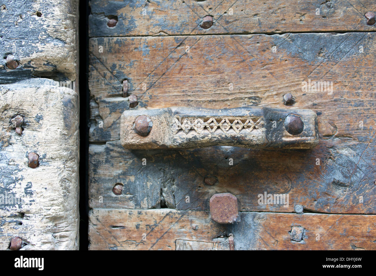 Ancient carved wooden handle on a door in Chianale Stock Photo - Alamy