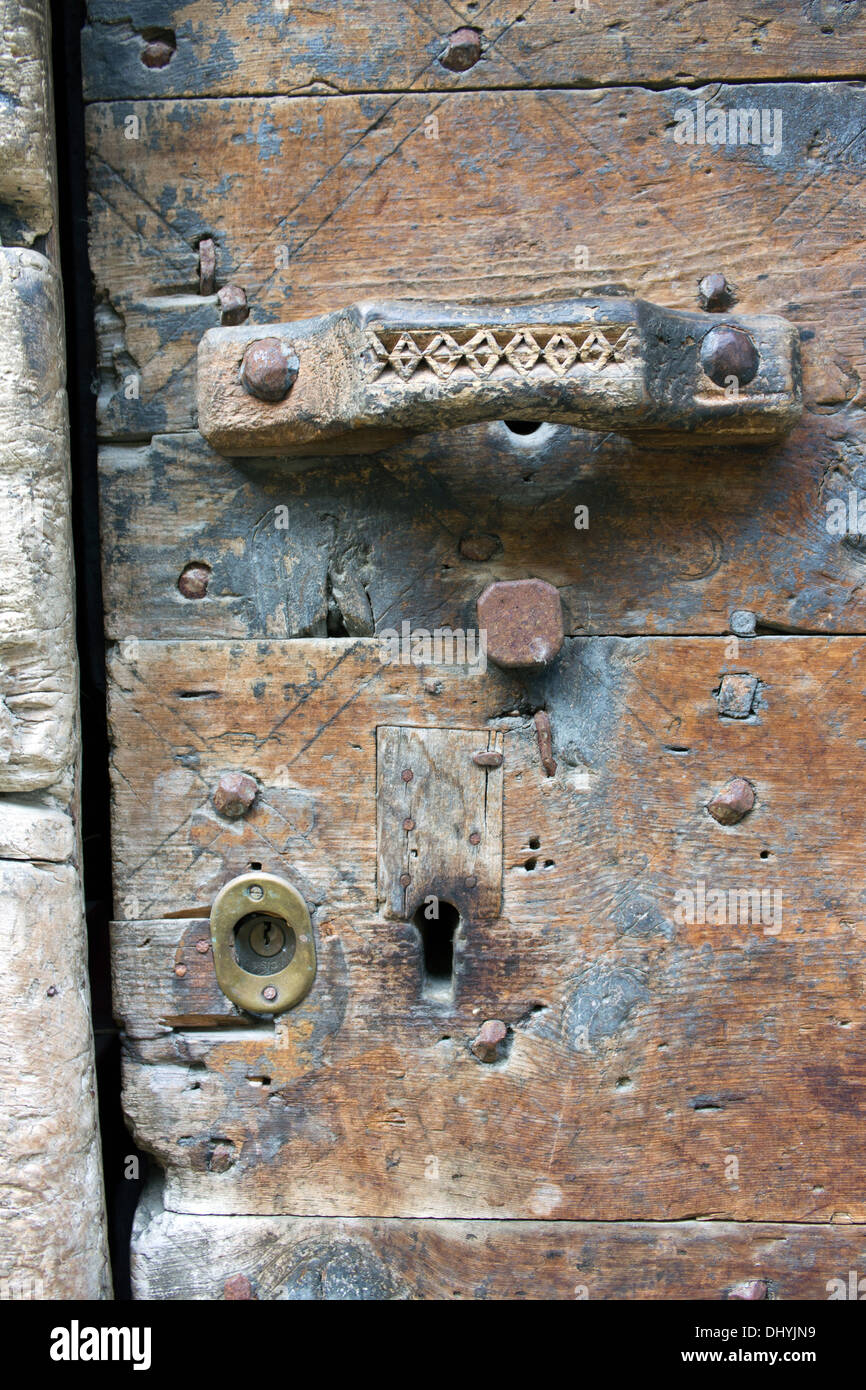 Ancient carved wooden handle on a door in Chianale Stock Photo - Alamy