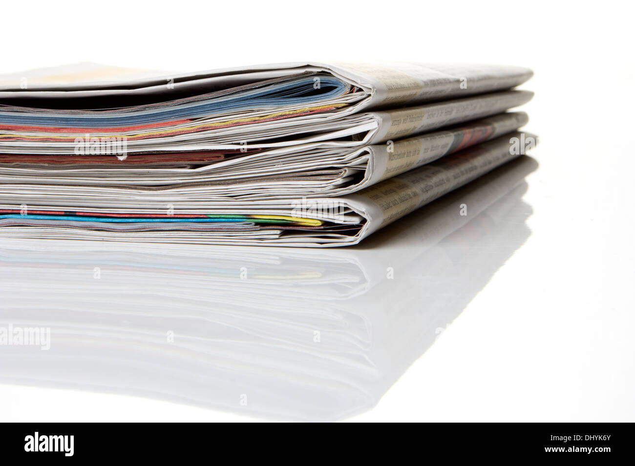 several newspapers, journals stacked on white background Stock Photo ...