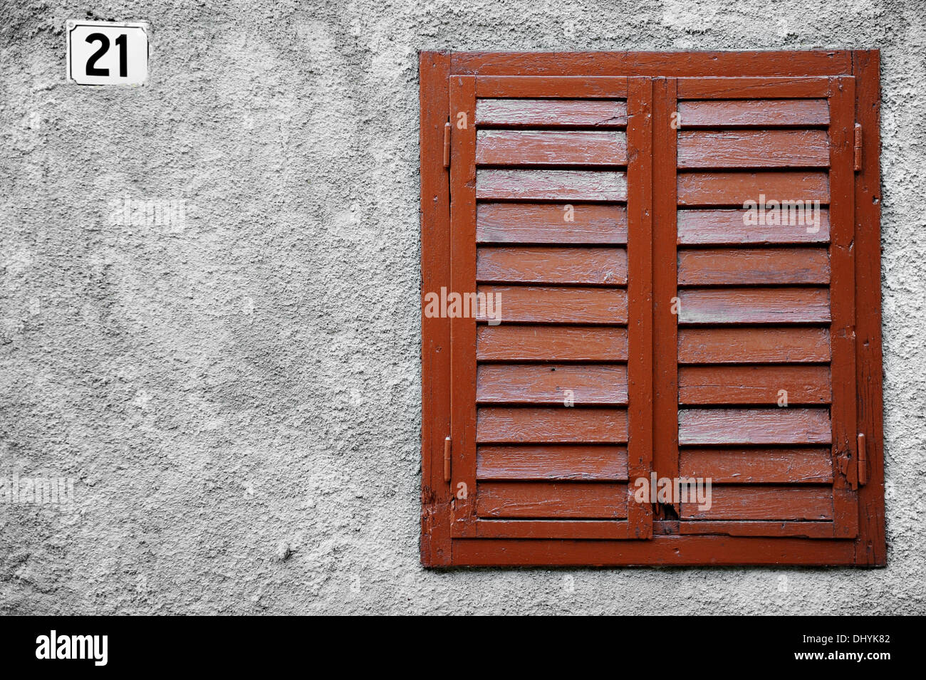 Brown wooden window with closed shutters and a home number Stock Photo ...