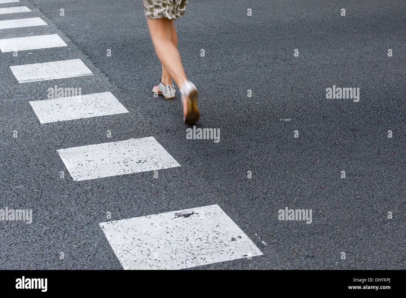 Walking on the street next to crossing lines Stock Photo - Alamy