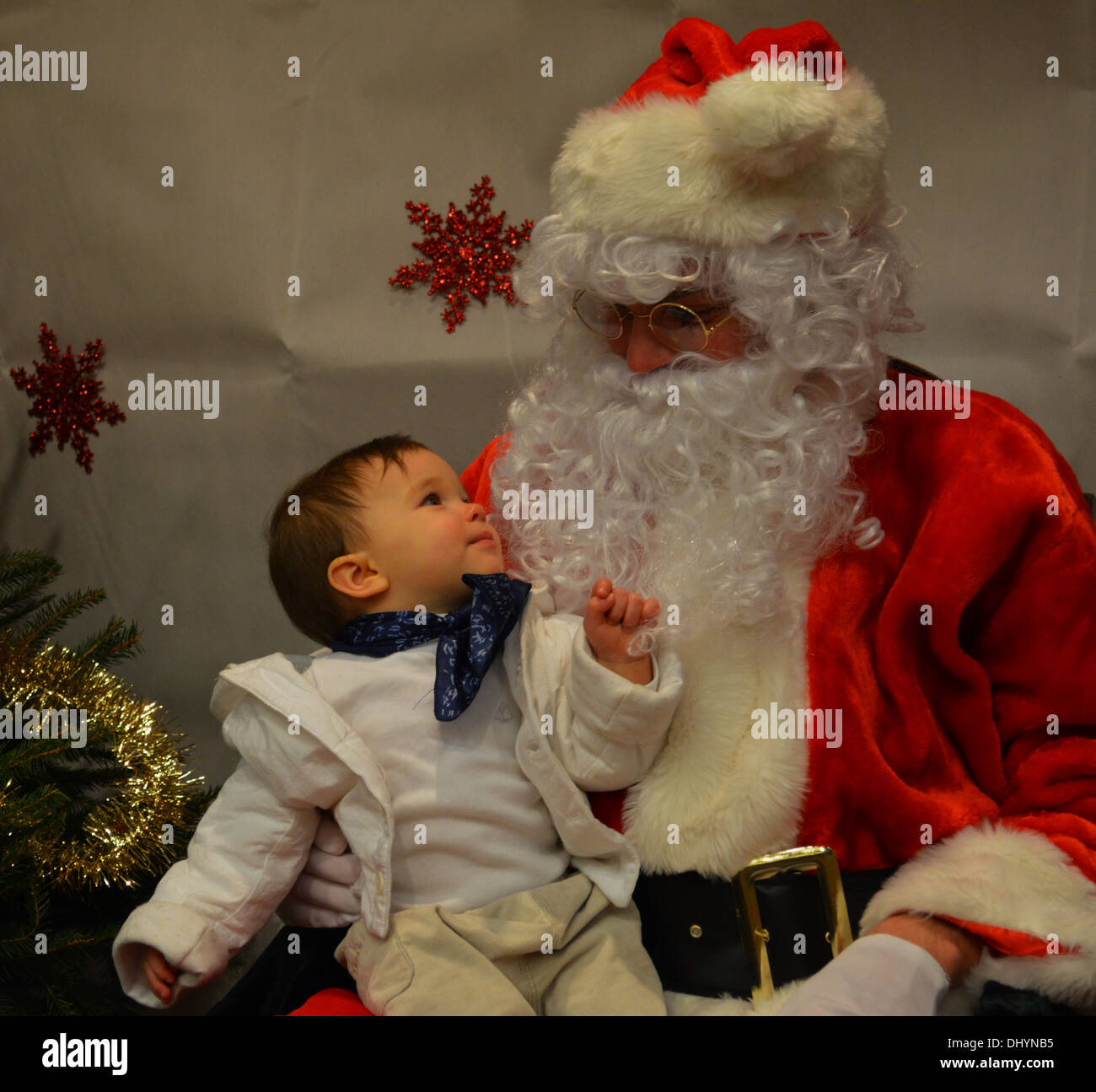 Baby looking at Santa Stock Photo - Alamy