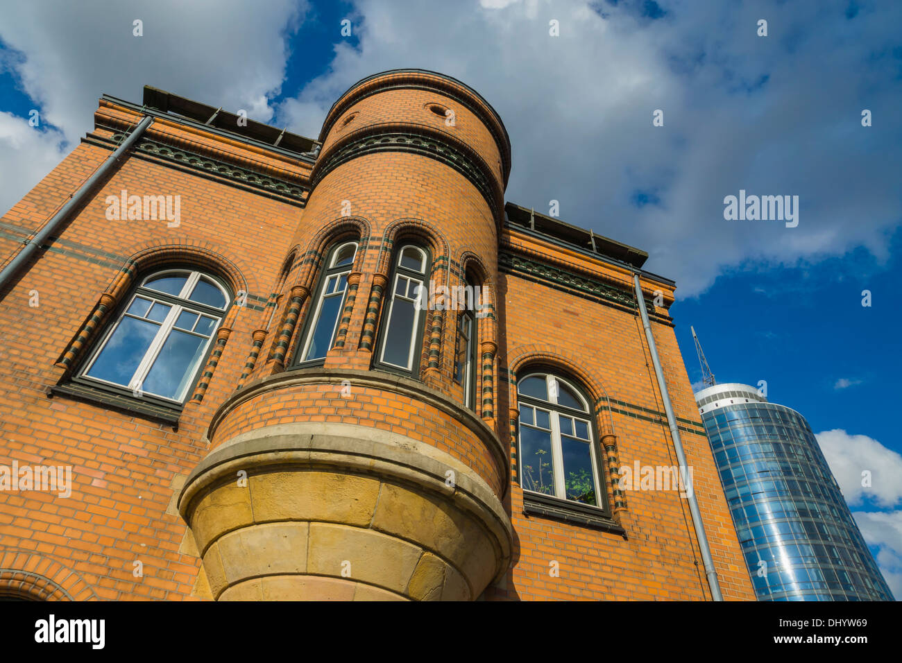 Old brick building with modern office building tower in Hamburg ...