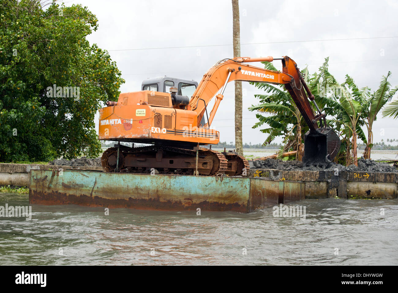 Excavator on barge in Kerala, India Stock Photo - Alamy