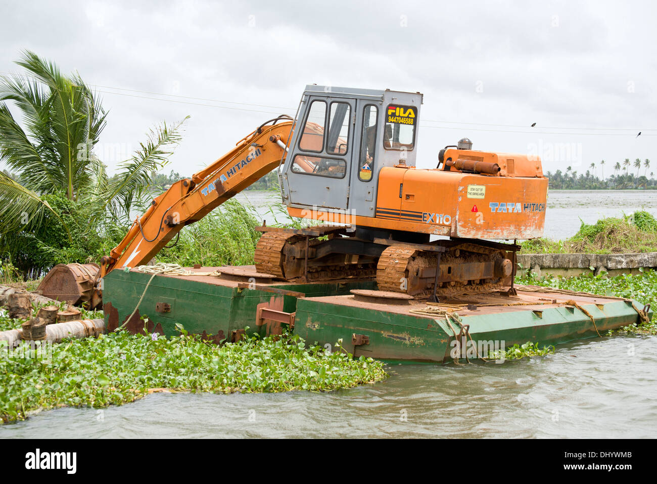 Excavator on barge in Kerala, India Stock Photo - Alamy