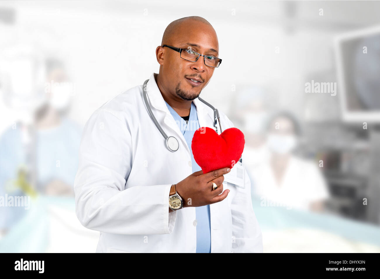 Dark skin doctor posing with a big red heart Stock Photo - Alamy