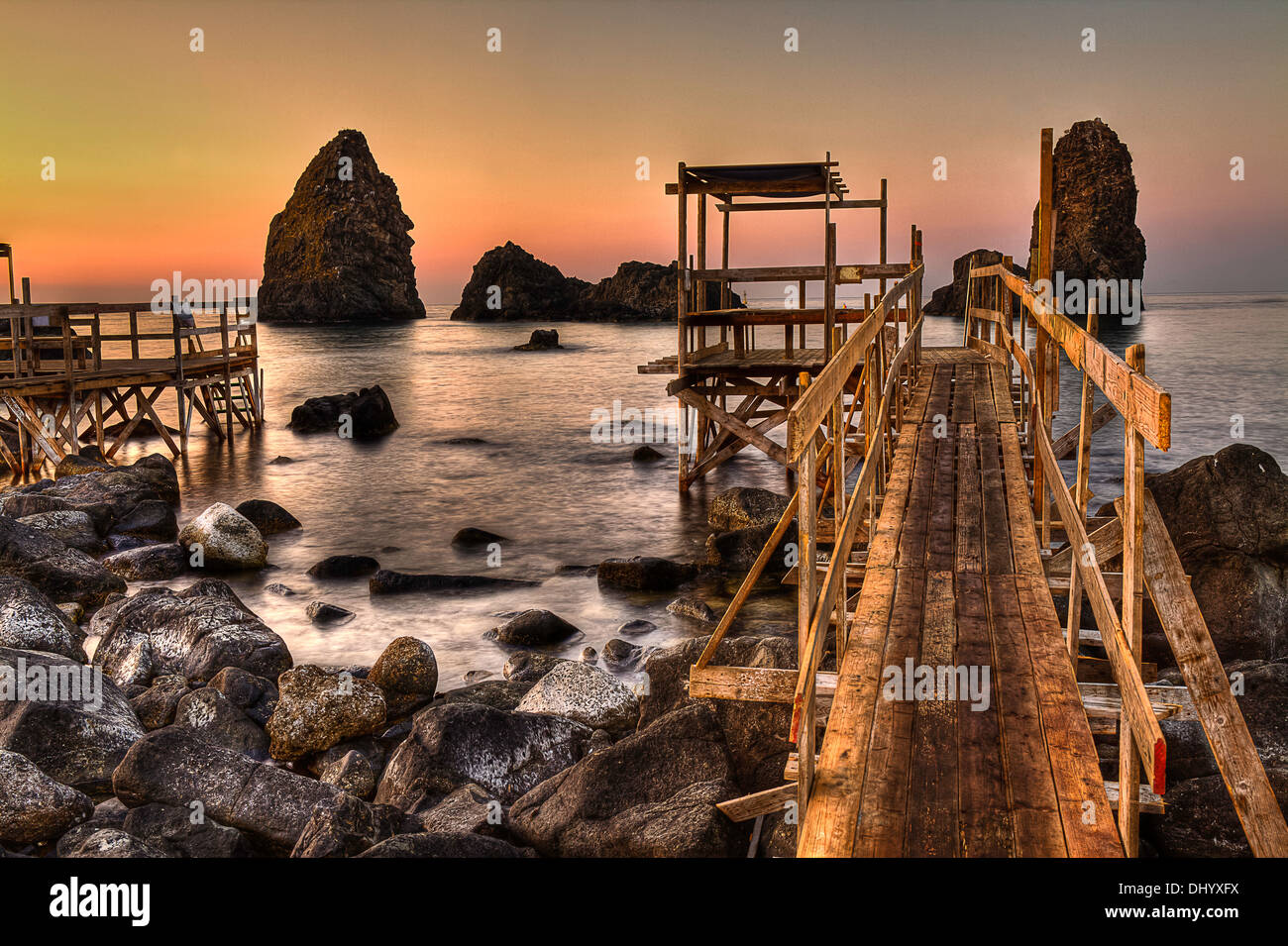 Aci Trezza fishing village of Sicily (Italy) cliffs at sunset Stock ...