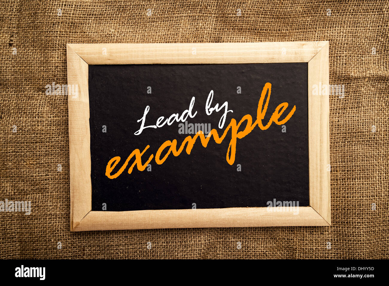 Lead by example note on black message board Stock Photo - Alamy