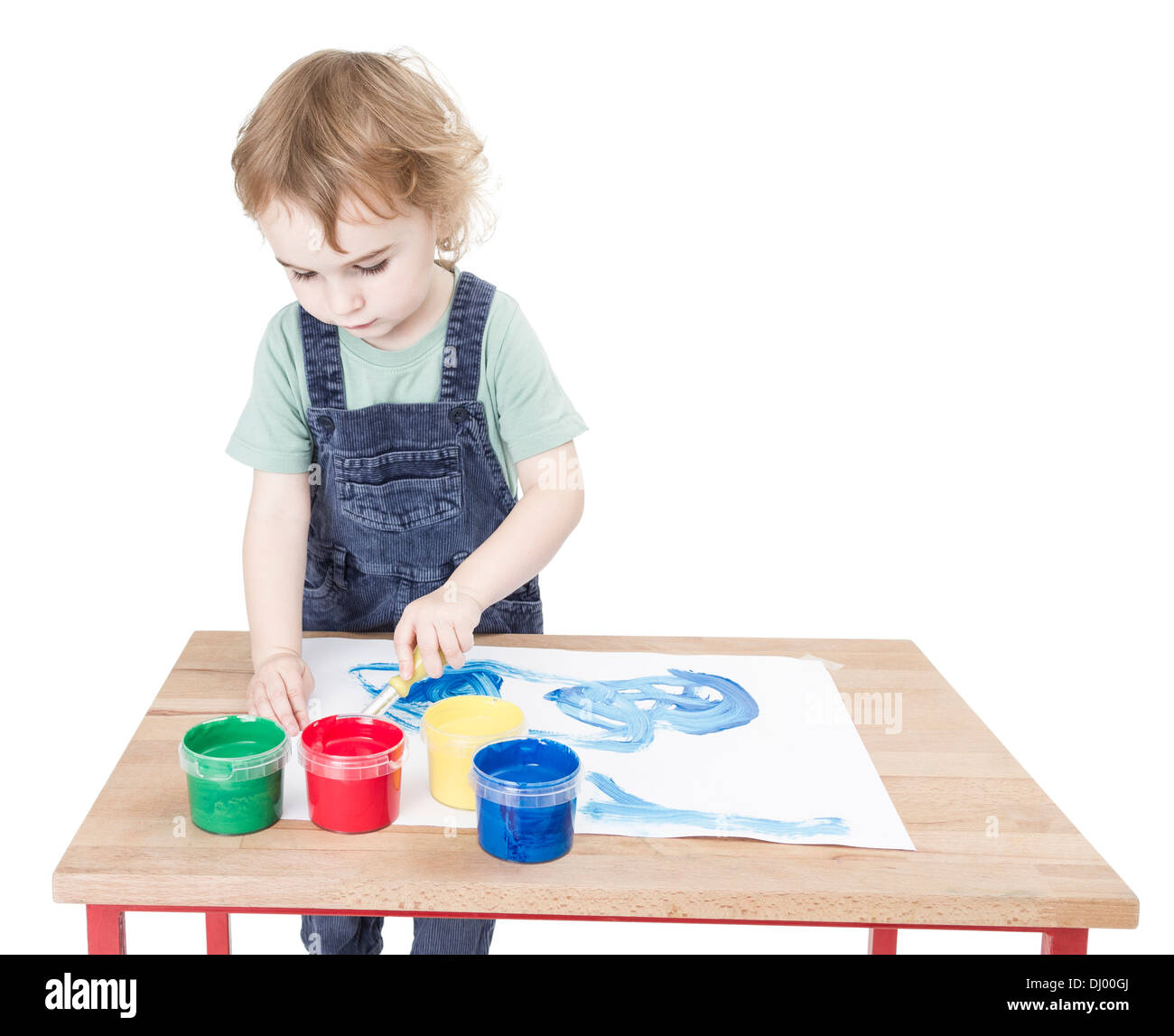 cute child making painting on small desk. studio shot isolated on white ...