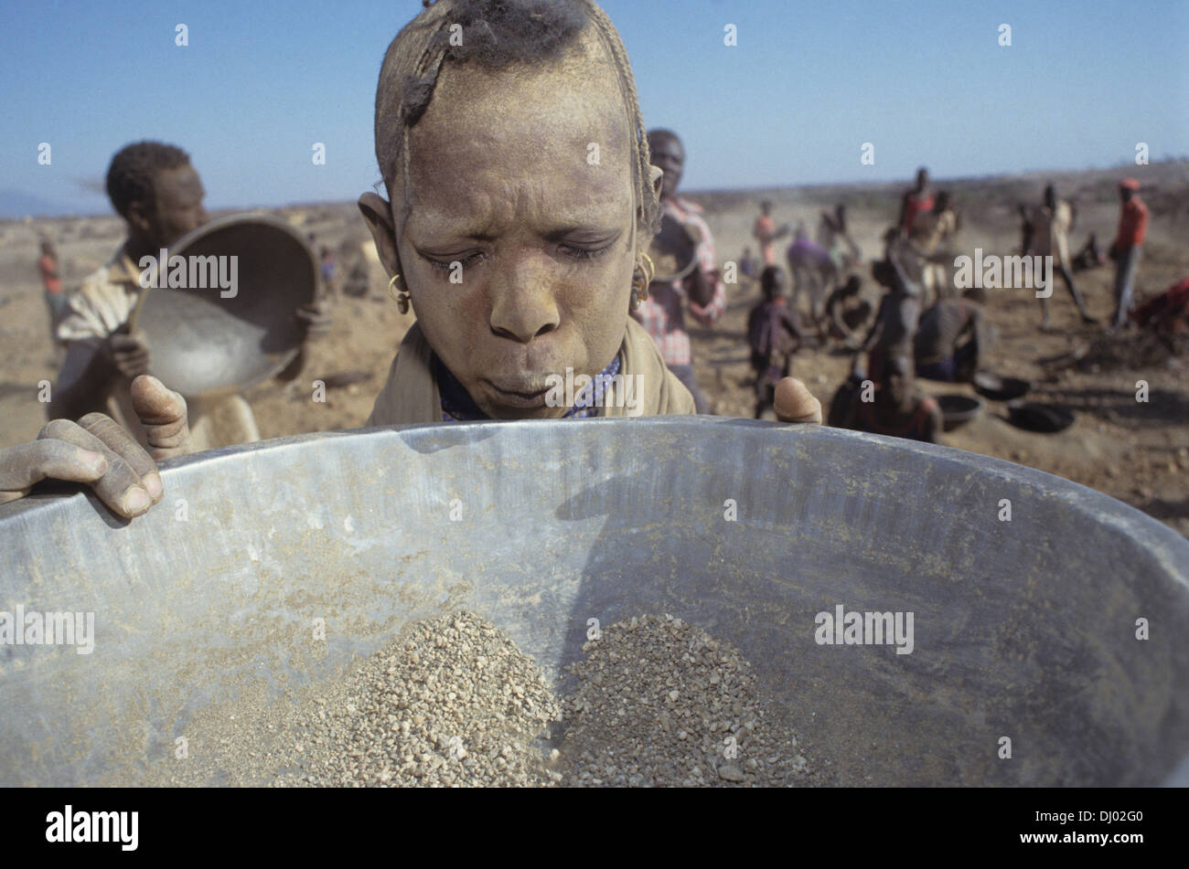 Gold mining ( dry panning) on the plains of Northern Turkana. Children ...