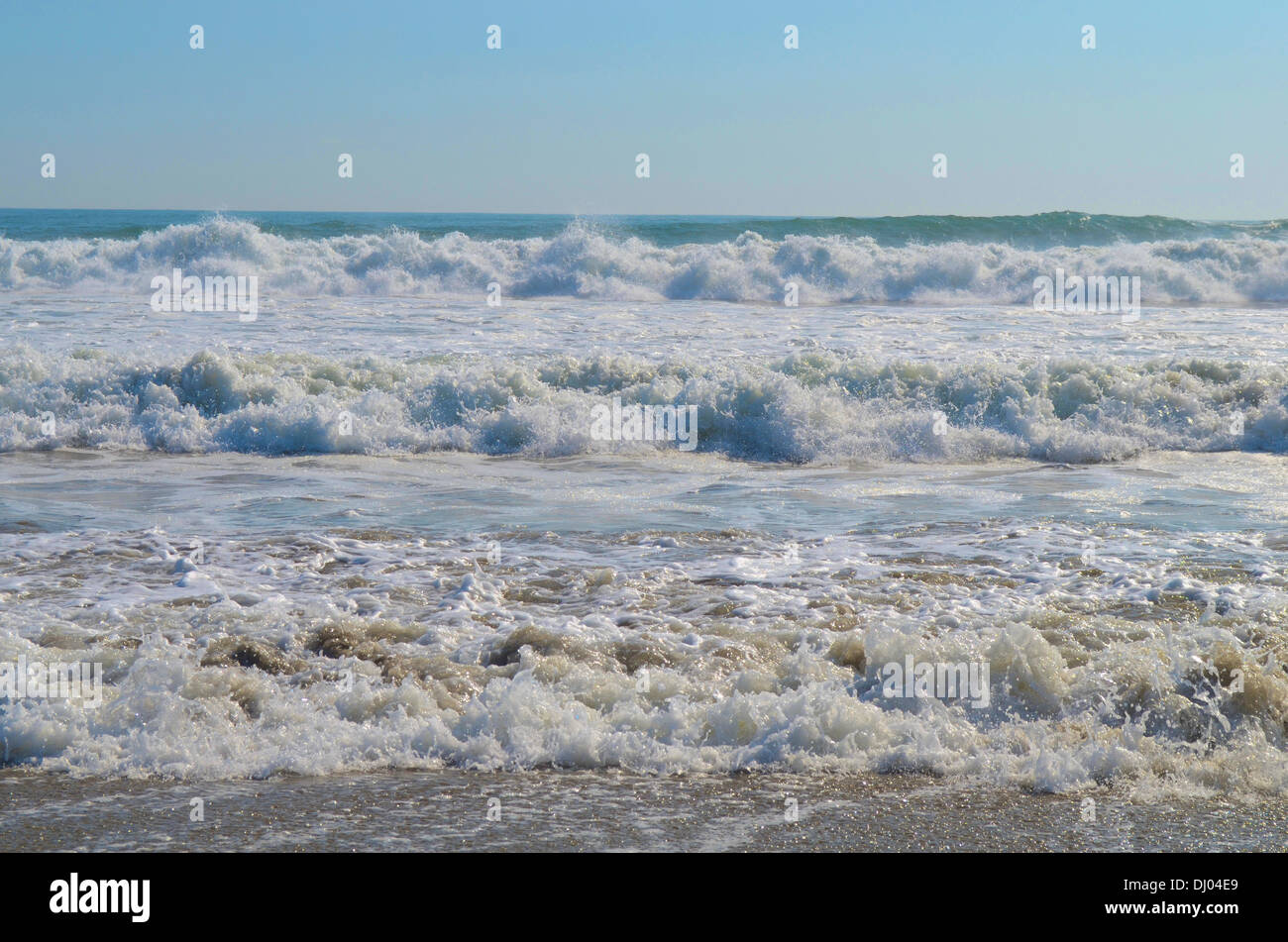Waves rolling onto the beach Stock Photo - Alamy