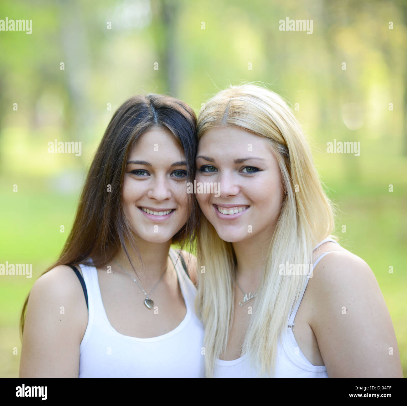 Portrait of two happy women looking at camera and smiling Stock Photo ...