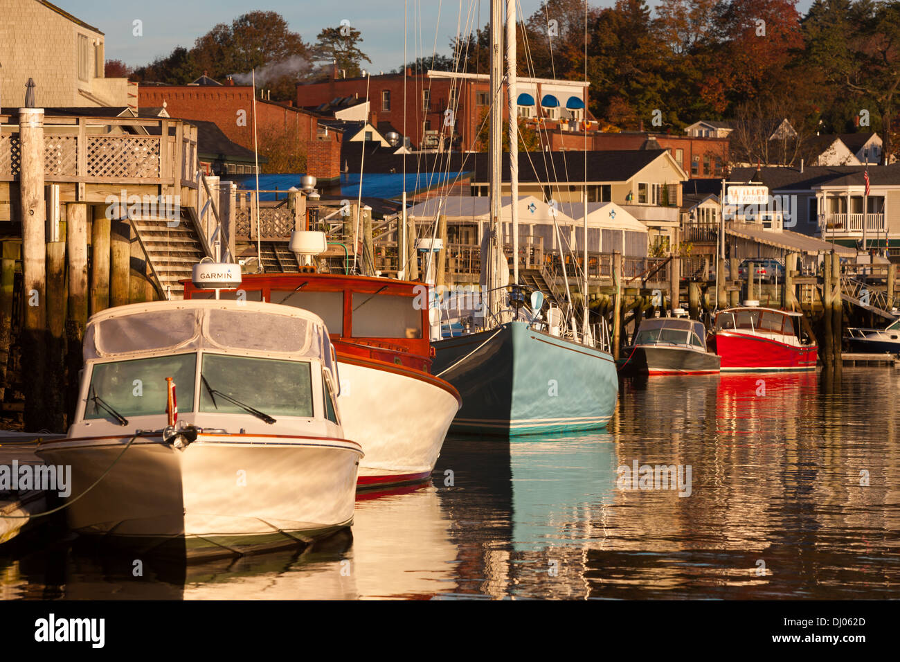 Boats and sailboats docked shortly after sunrise in Camden harbor ...