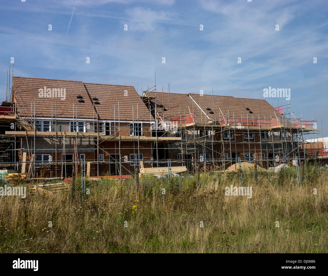 new house homes building scaffolding roofs Stock Photo - Alamy