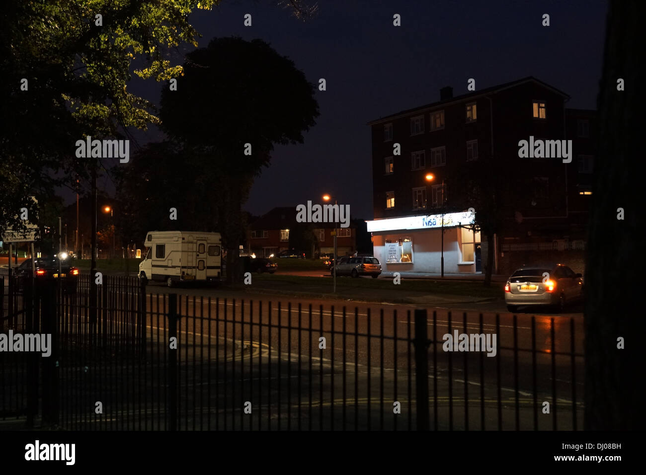 convenience corner shop indicating cars night Stock Photo - Alamy