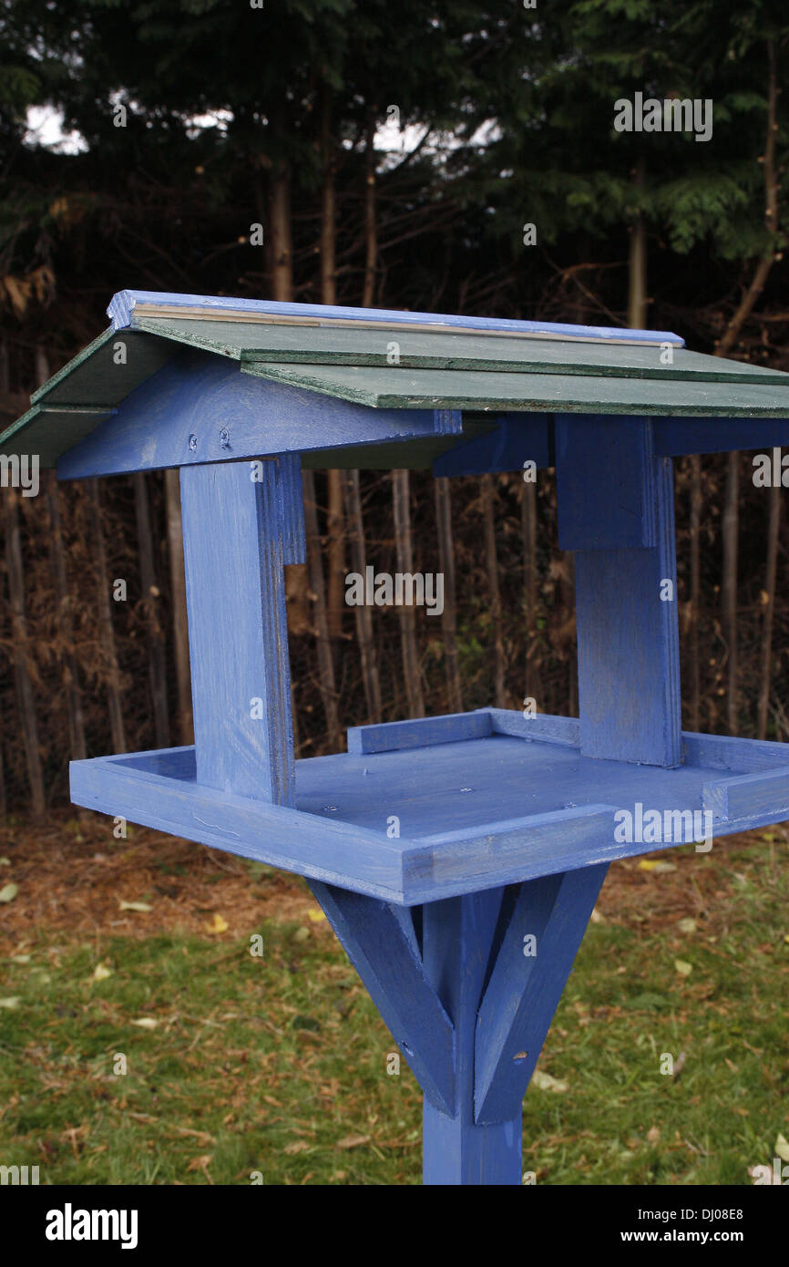 painted blue and green bird table in garden Stock Photo - Alamy