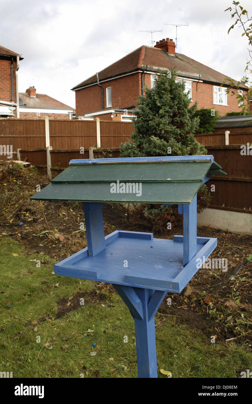 painted blue and green bird table in garden Stock Photo - Alamy