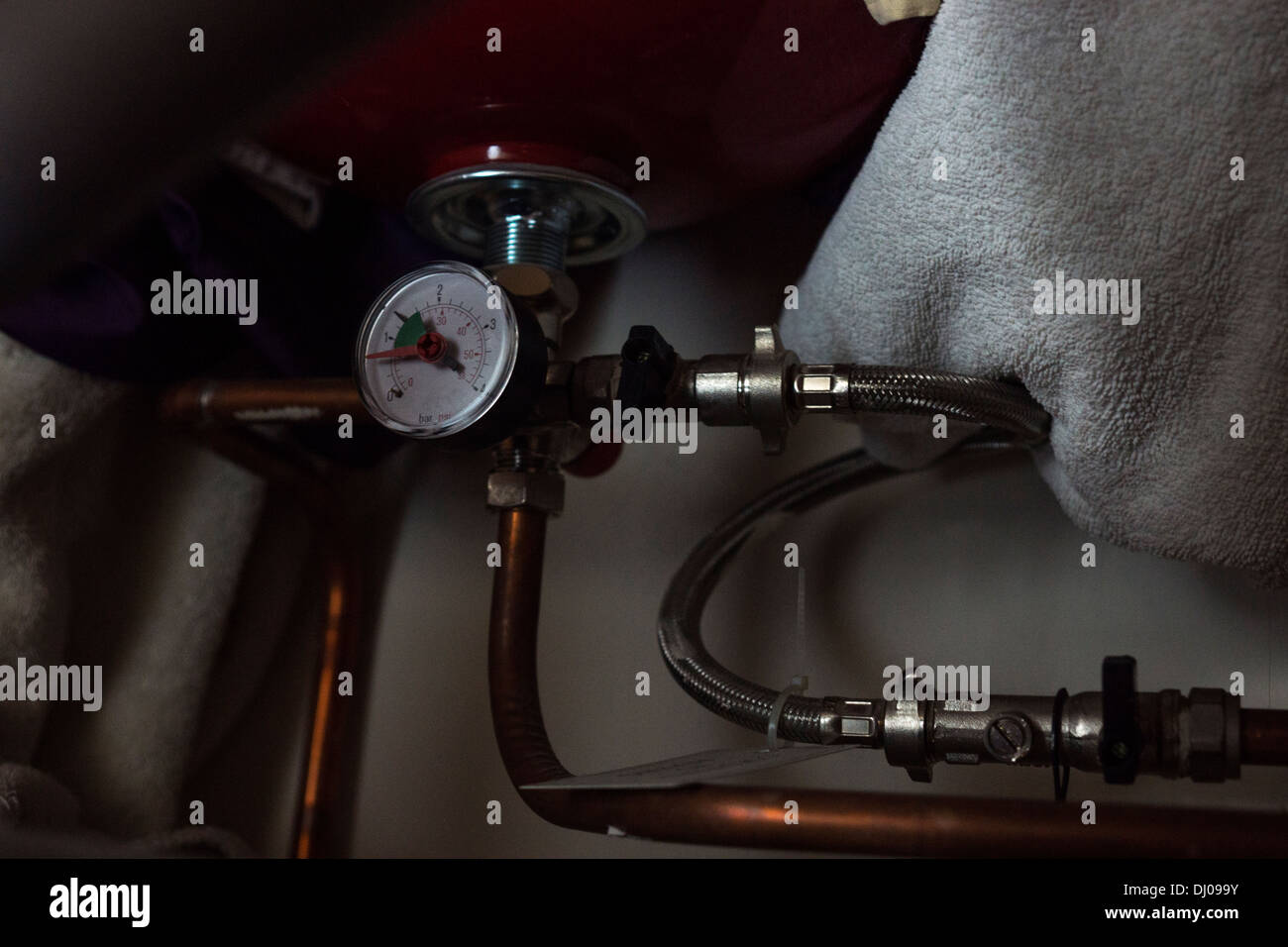 red house boiler clock metal coper pipes towels Stock Photo - Alamy