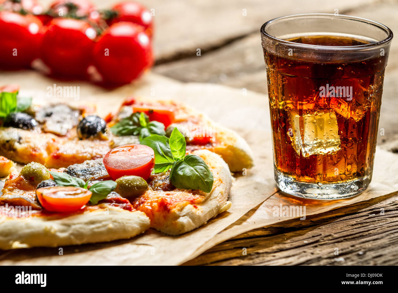 Baked pizza and served with cold drink Stock Photo - Alamy