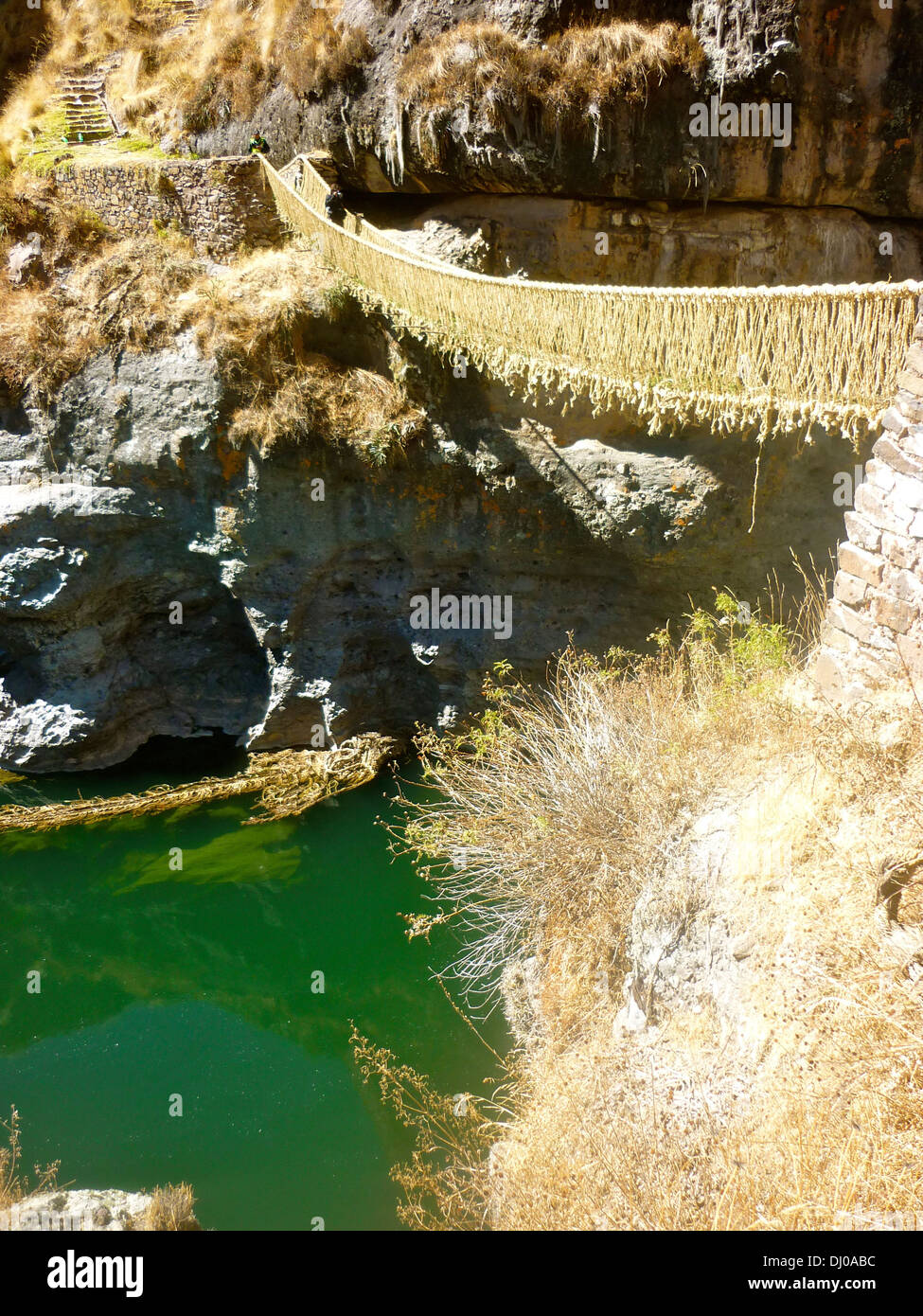Qeswachaca Inca Bridge, a traditional woven grass rope bridge across ...