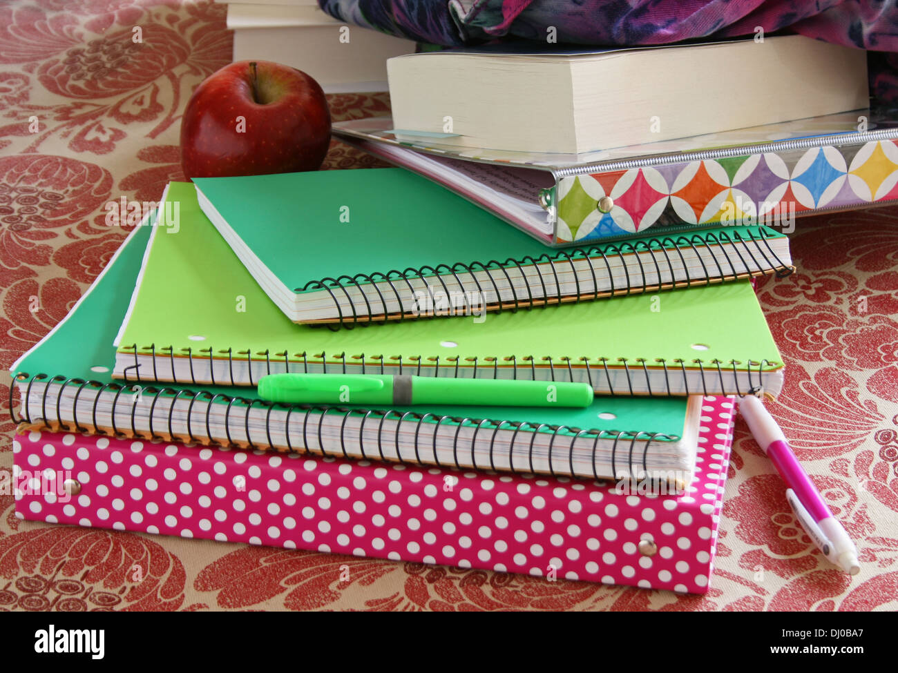 Closeup of school notebooks on a table with an apple Stock Photo - Alamy