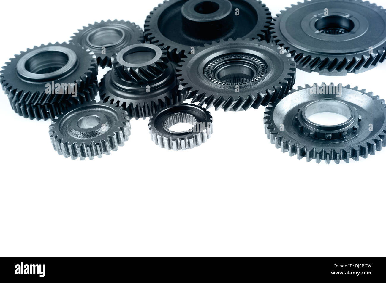 Steel cog gears on plain background Stock Photo - Alamy