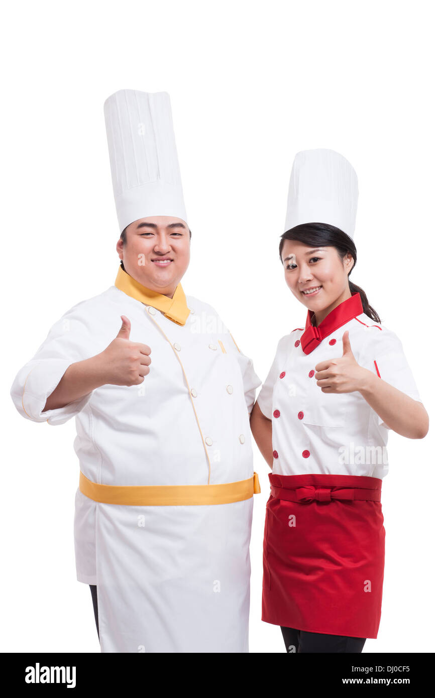 Cheerful cooks doing thumbs up Stock Photo - Alamy