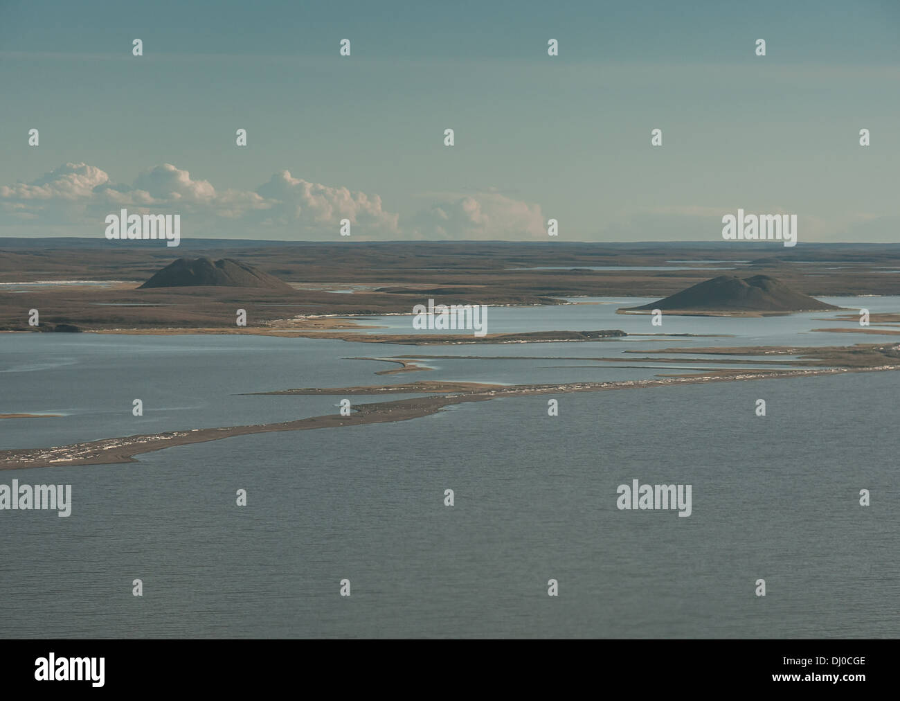 an aerial view of two pingo formations at the shore of the Arctic Ocean ...
