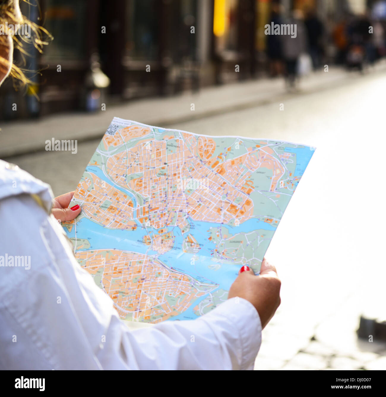 Tourist looking at City map outdoors Stock Photo - Alamy