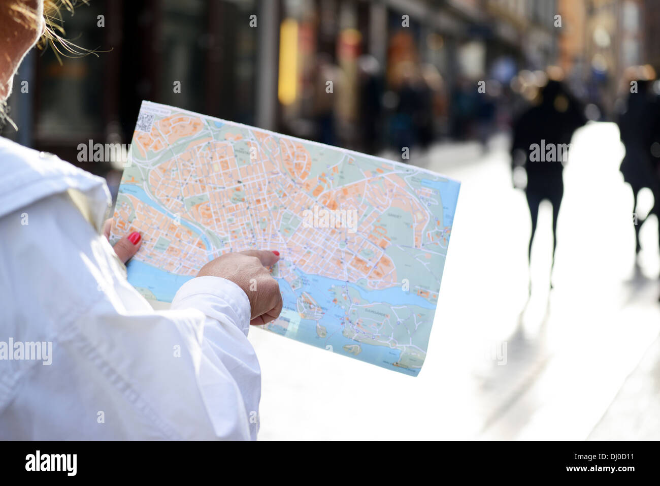 Tourist looking at City map Stock Photo - Alamy