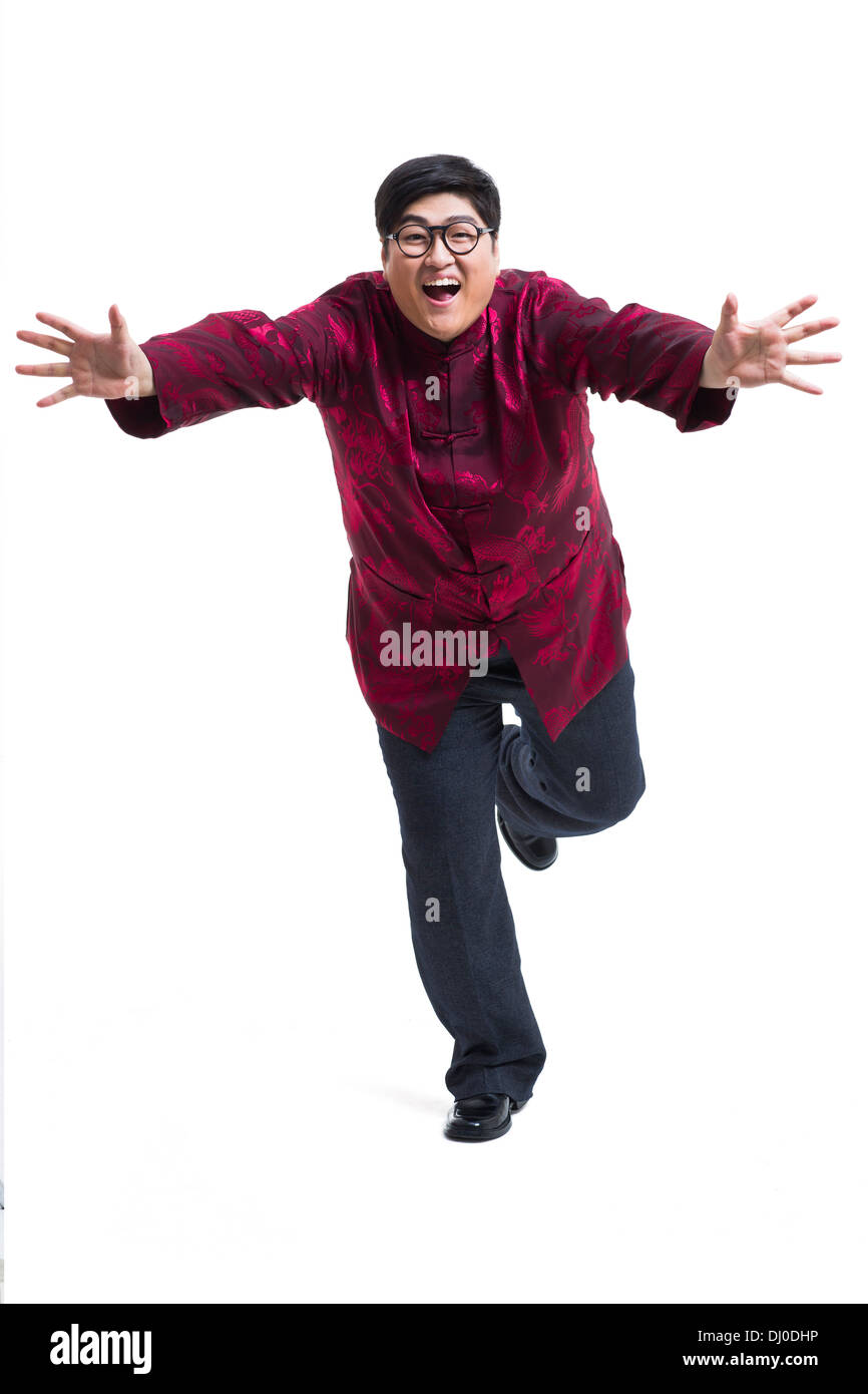 Excited young man in Tang suit reaching out Stock Photo - Alamy