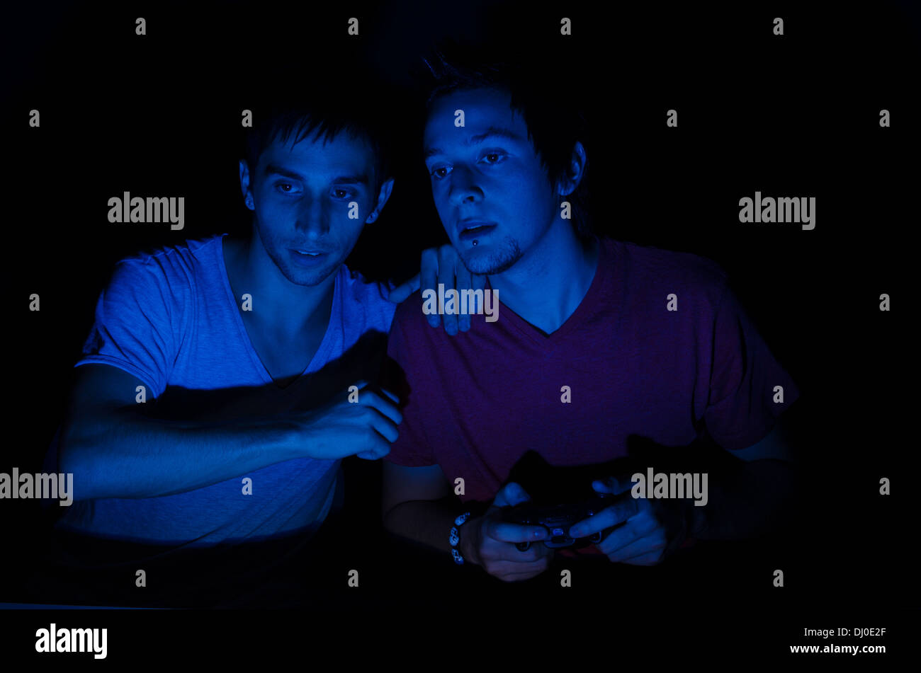 Two friends in front of a computer screen gaming Stock Photo - Alamy
