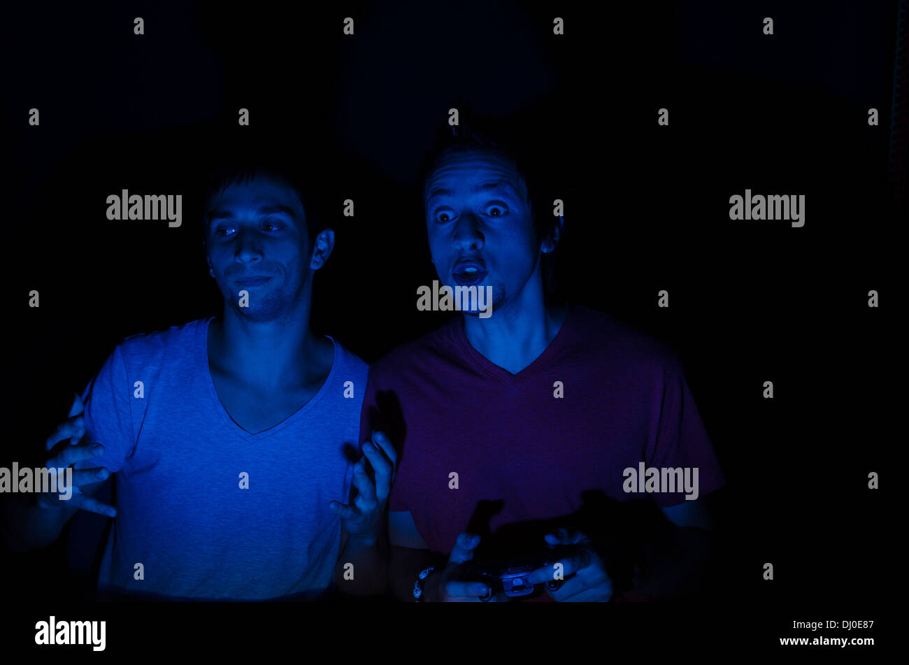 Excitement in front of a screen while playing video games Stock Photo ...