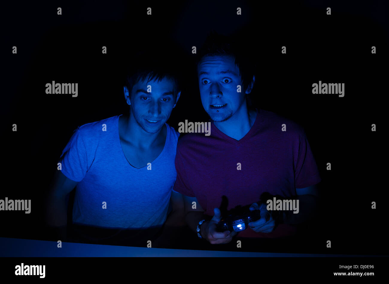 Excitement in front of a screen while playing video games Stock Photo ...