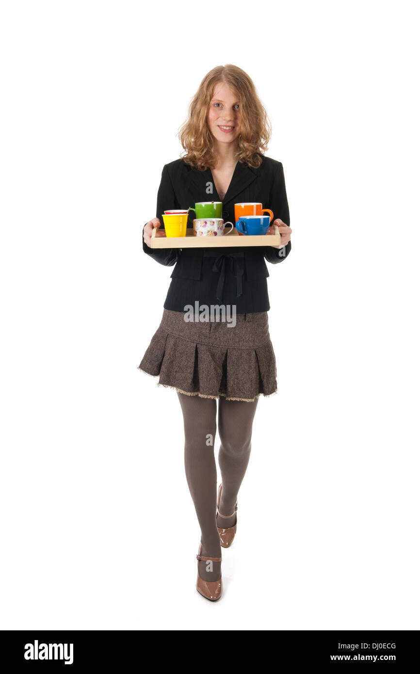 Young woman at work is bringing coffee for the colleagues Stock Photo ...